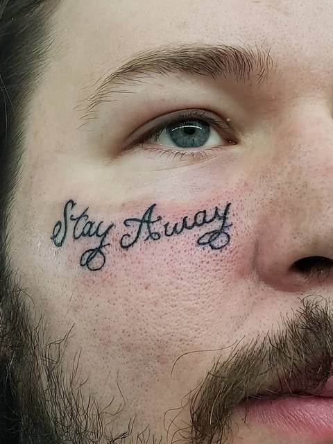 Script Tattoos on Face